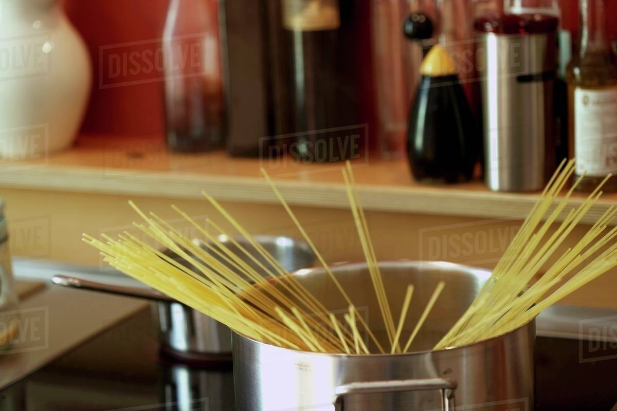 Spaghetti in a pan on a cooker - Royalty-free Stock Photo | Dissolve