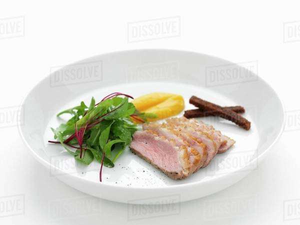 Roast duck breast with accompaniments - Stock Photo - Dissolve