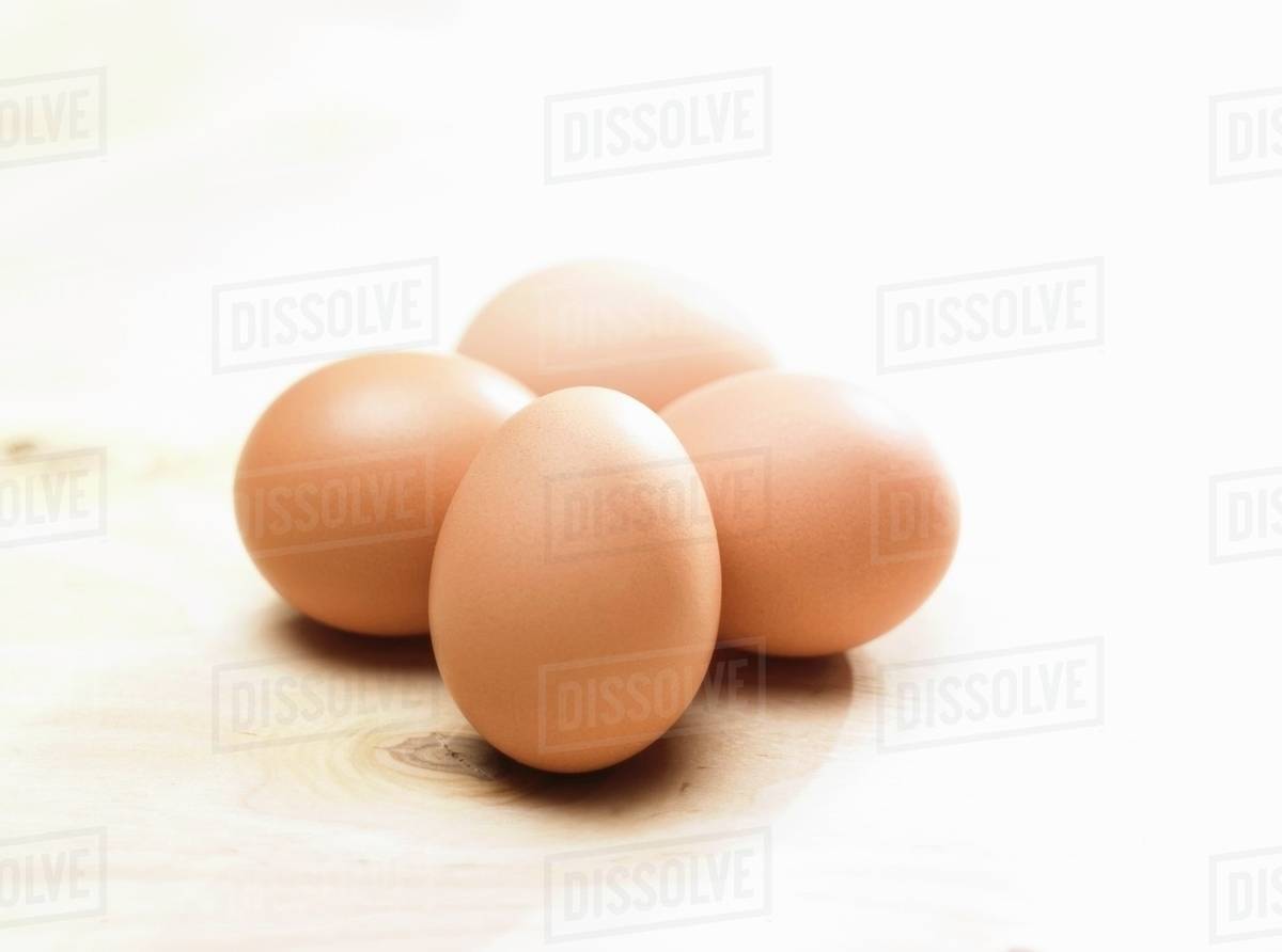 Four hens' eggs - Stock Photo - Dissolve