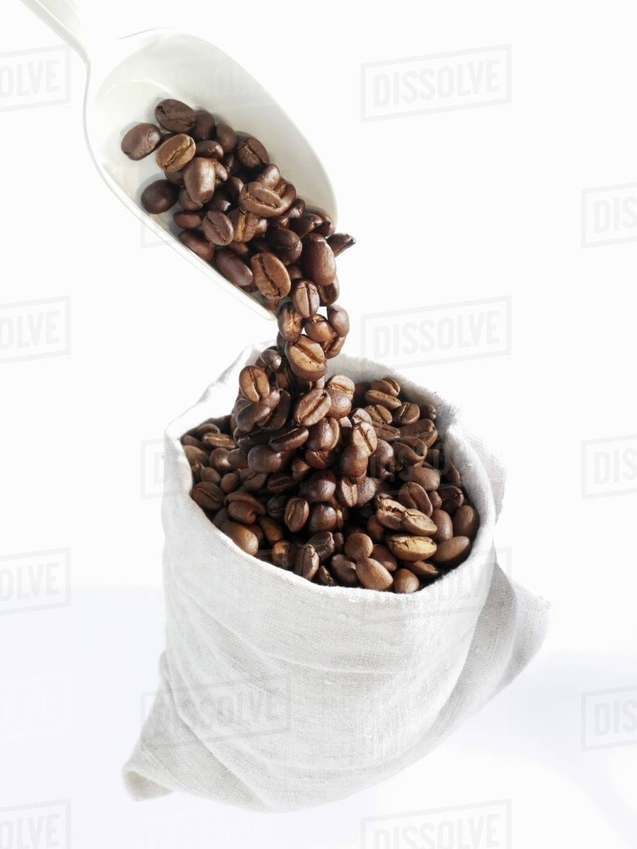 Pouring coffee beans into a bag - Royalty-free Stock Photo | Dissolve