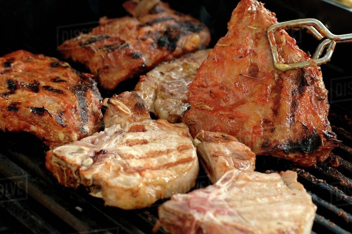 Various types of meat on barbecue - Royalty-free Stock Photo | Dissolve