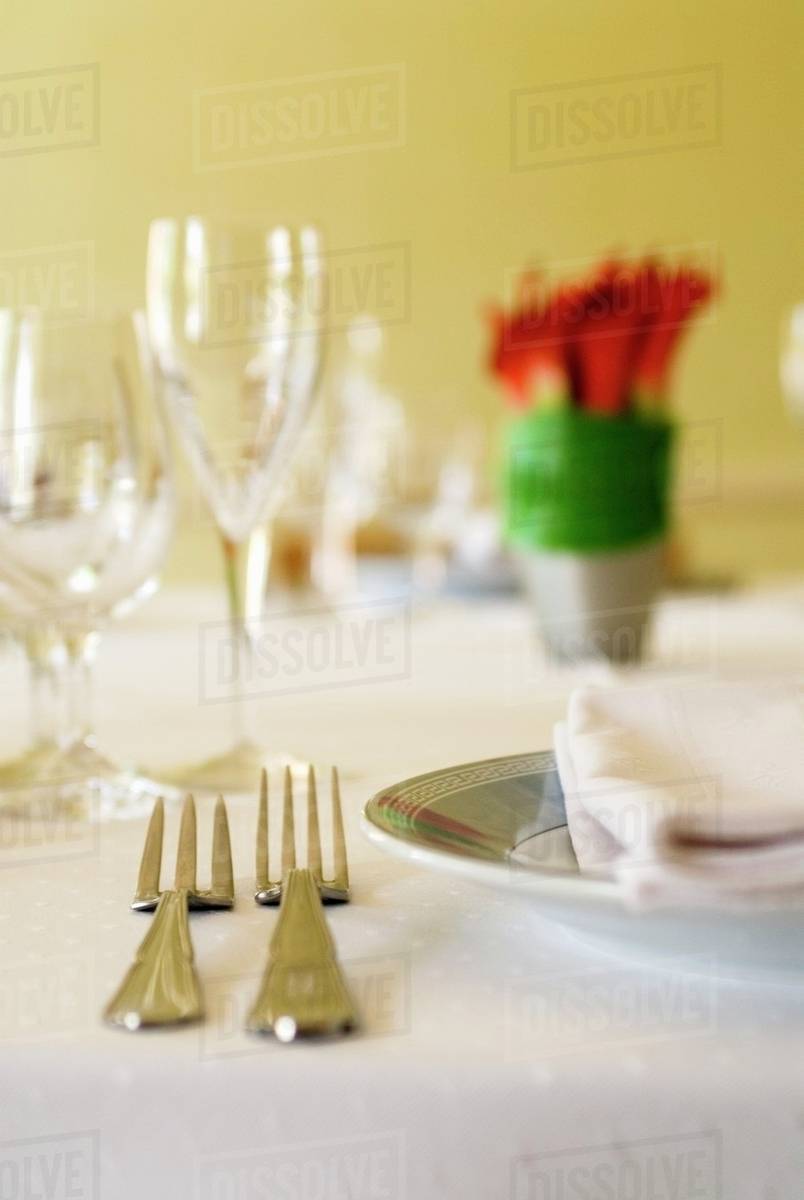 Table laid for two with vase of flowers - Royalty-free Stock Photo ...
