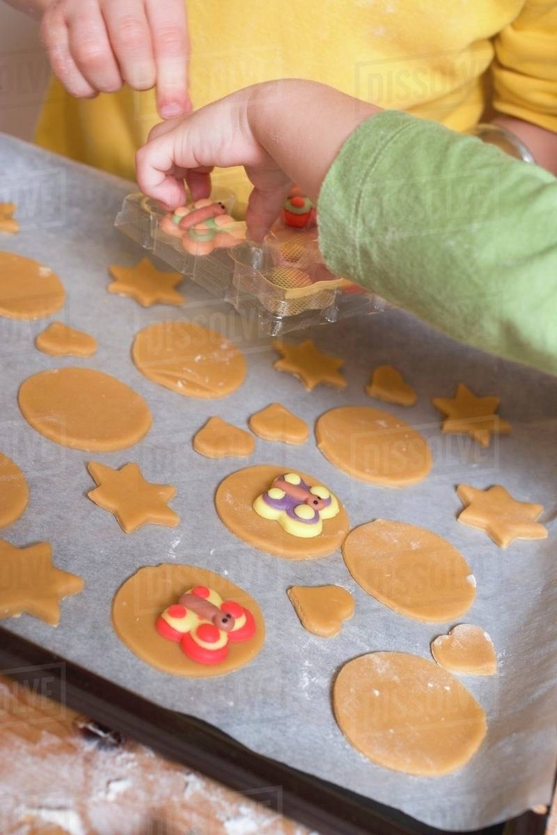 Children decorating biscuits - Stock Photo - Dissolve