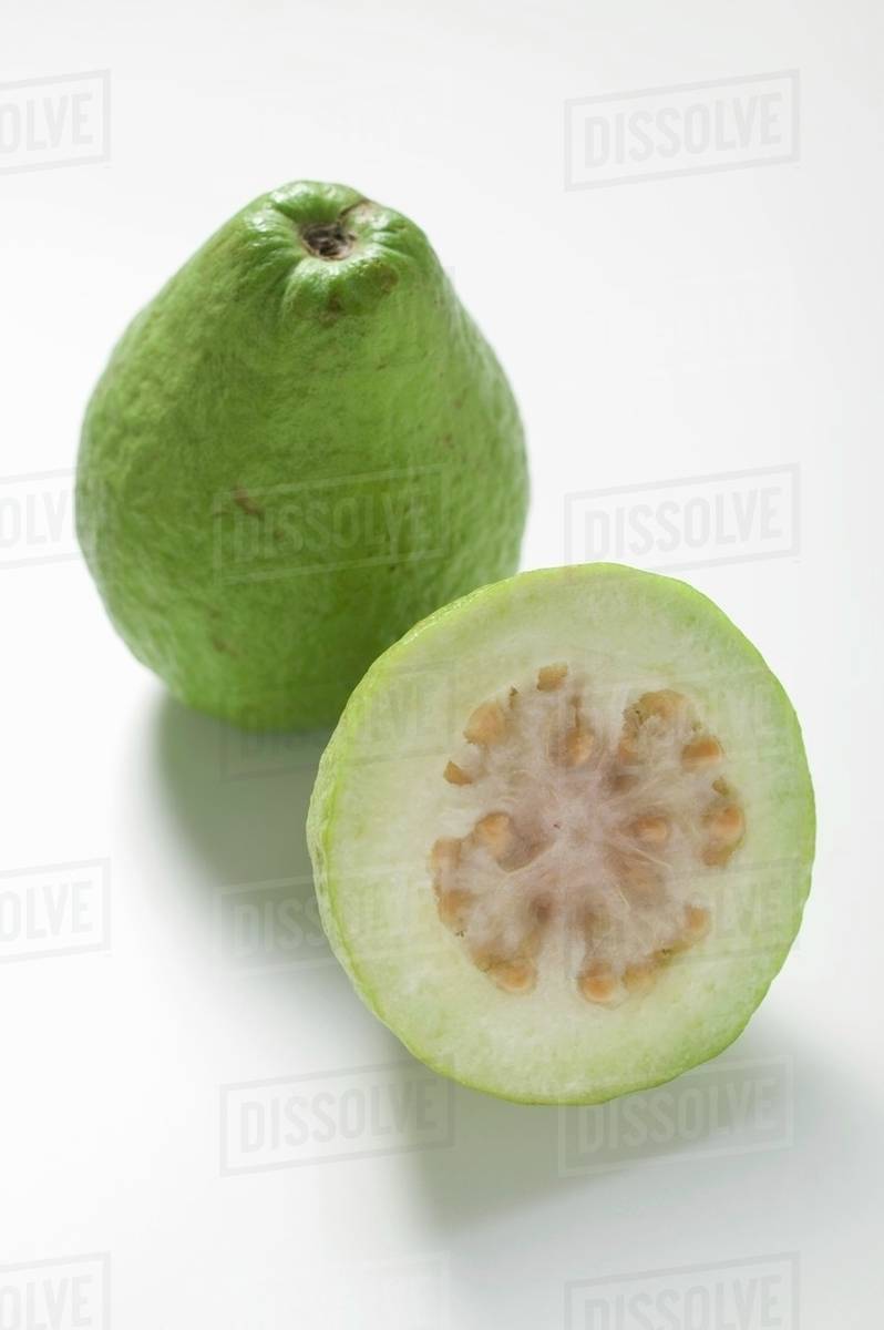 Whole guava and half a guava - Royalty-free Stock Photo | Dissolve