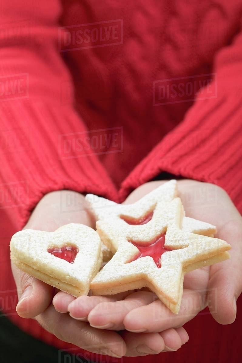 Hands holding jam biscuits - Royalty-free Stock Photo | Dissolve