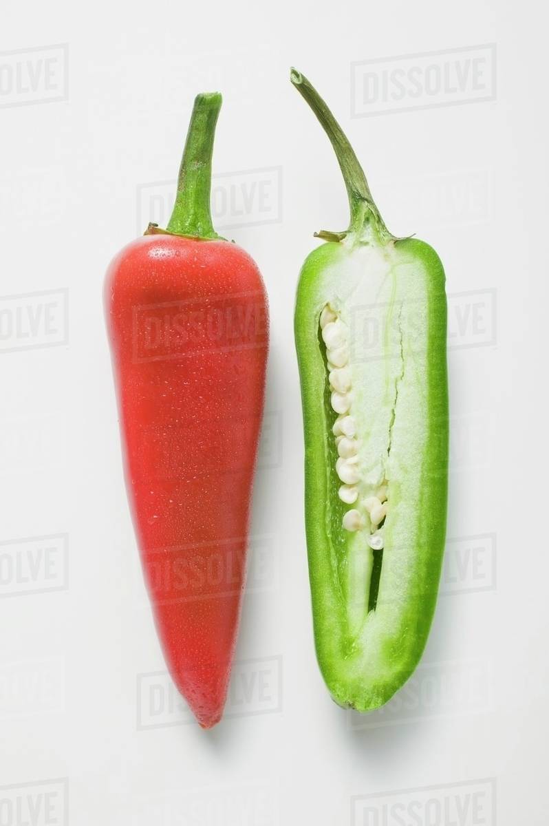 Whole red chilli and half a green chilli - Royalty-free Stock Photo ...