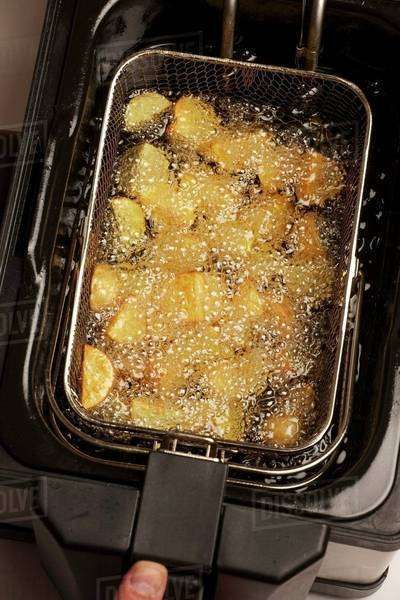 Potatoes being fried in a deep fat fryer - Royalty-free Stock Photo ...