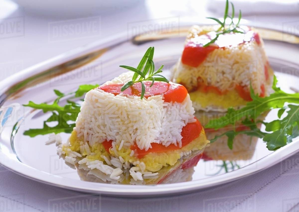 Rice timbales with fried peppers, rosemary and rocket - Royalty-free ...