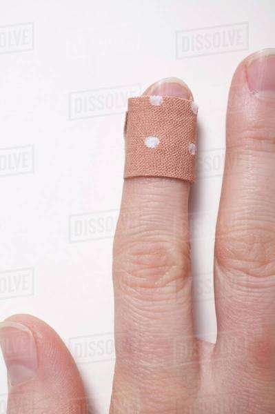 Finger with sticking plaster - Royalty-free Stock Photo | Dissolve