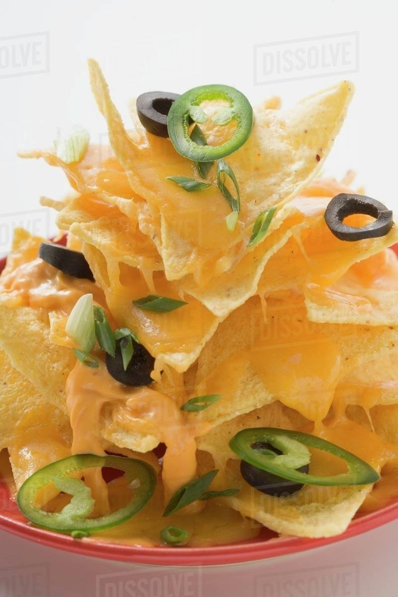 Nachos with cheese, olives and chilli rings - Stock Photo - Dissolve