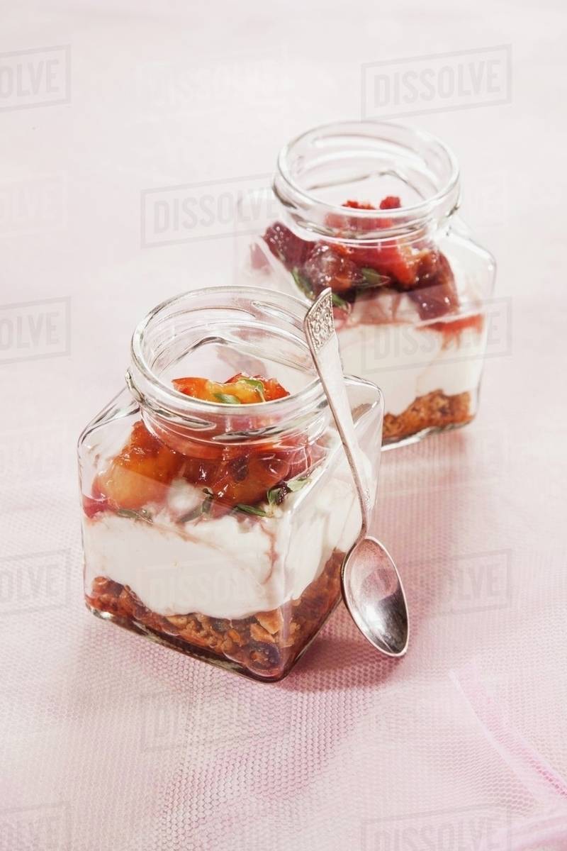 Layered desserts made with muesli, quark and nectarines in jars ...