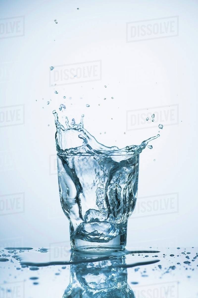 Water splashing out of a glass - Stock Photo - Dissolve