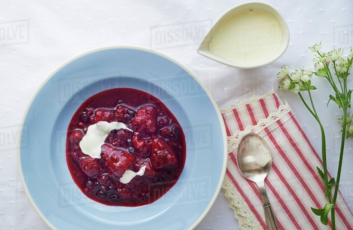 Red berry compote with cream - Royalty-free Stock Photo | Dissolve