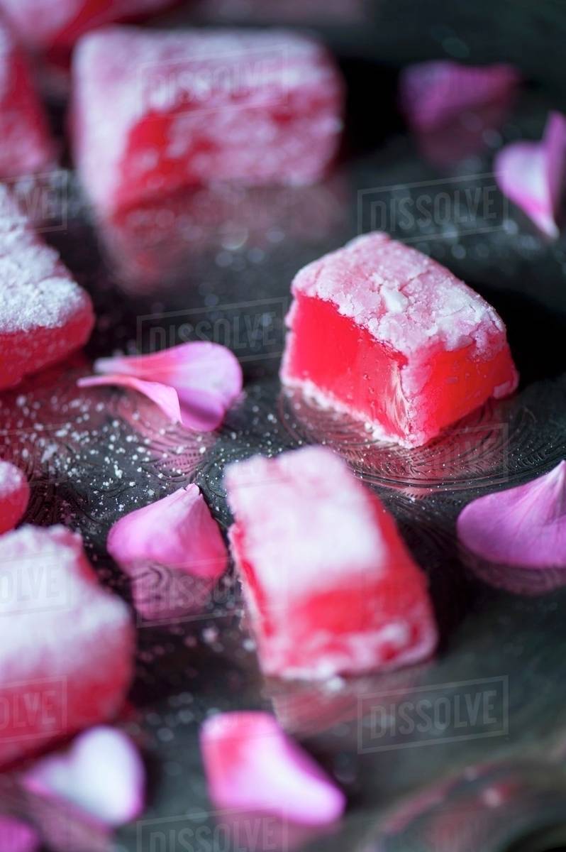 Sliced pieces of Turkish Delight with rose petals - Stock Photo - Dissolve