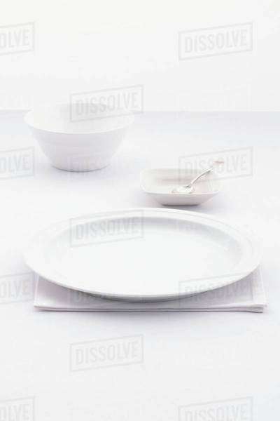 An all-white place setting - Stock Photo - Dissolve