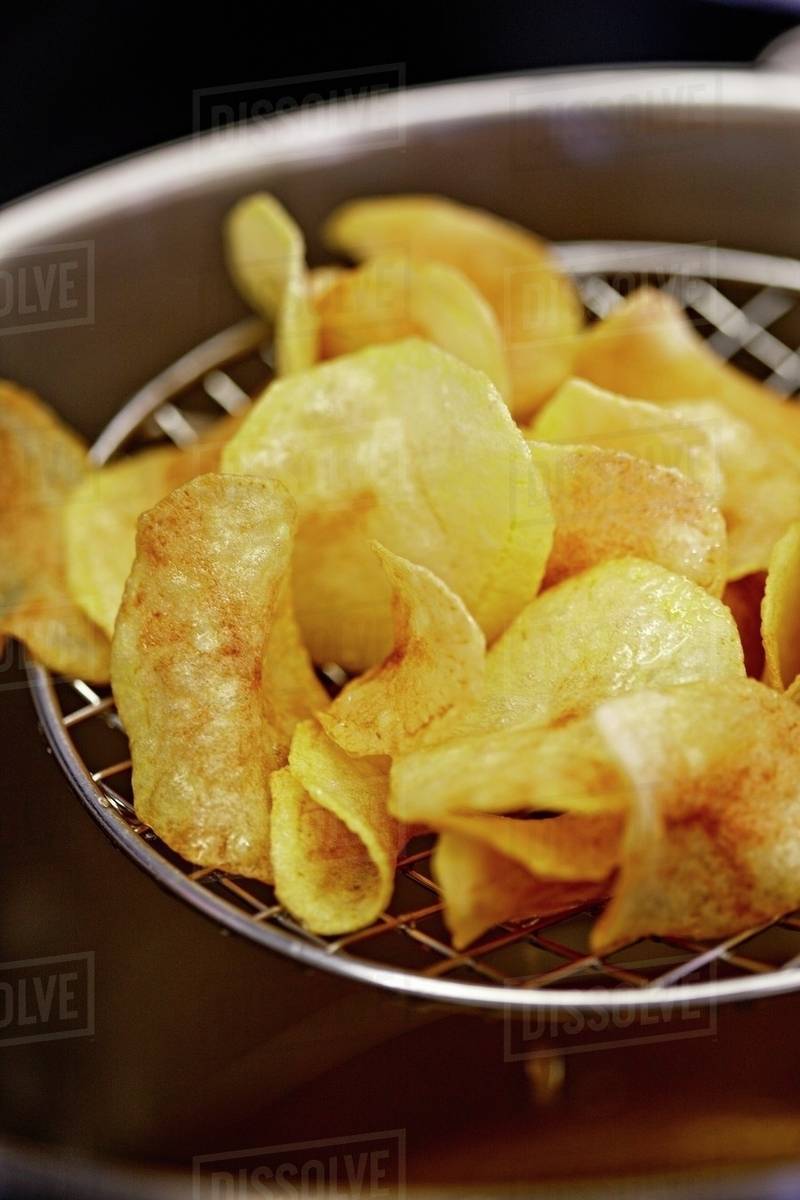 Making potato crisps - Royalty-free Stock Photo | Dissolve