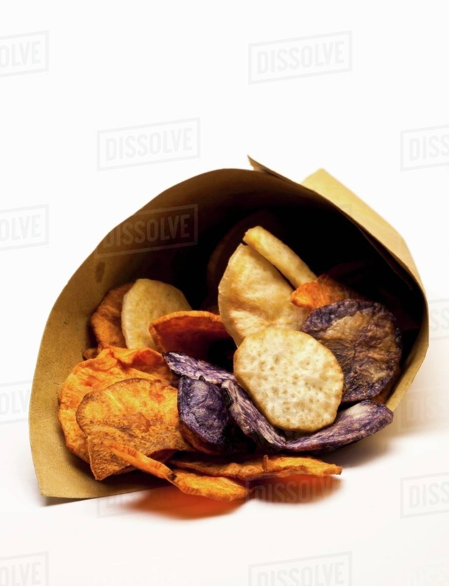 Various different coloured potato crisps in a paper bag - Royalty-free ...