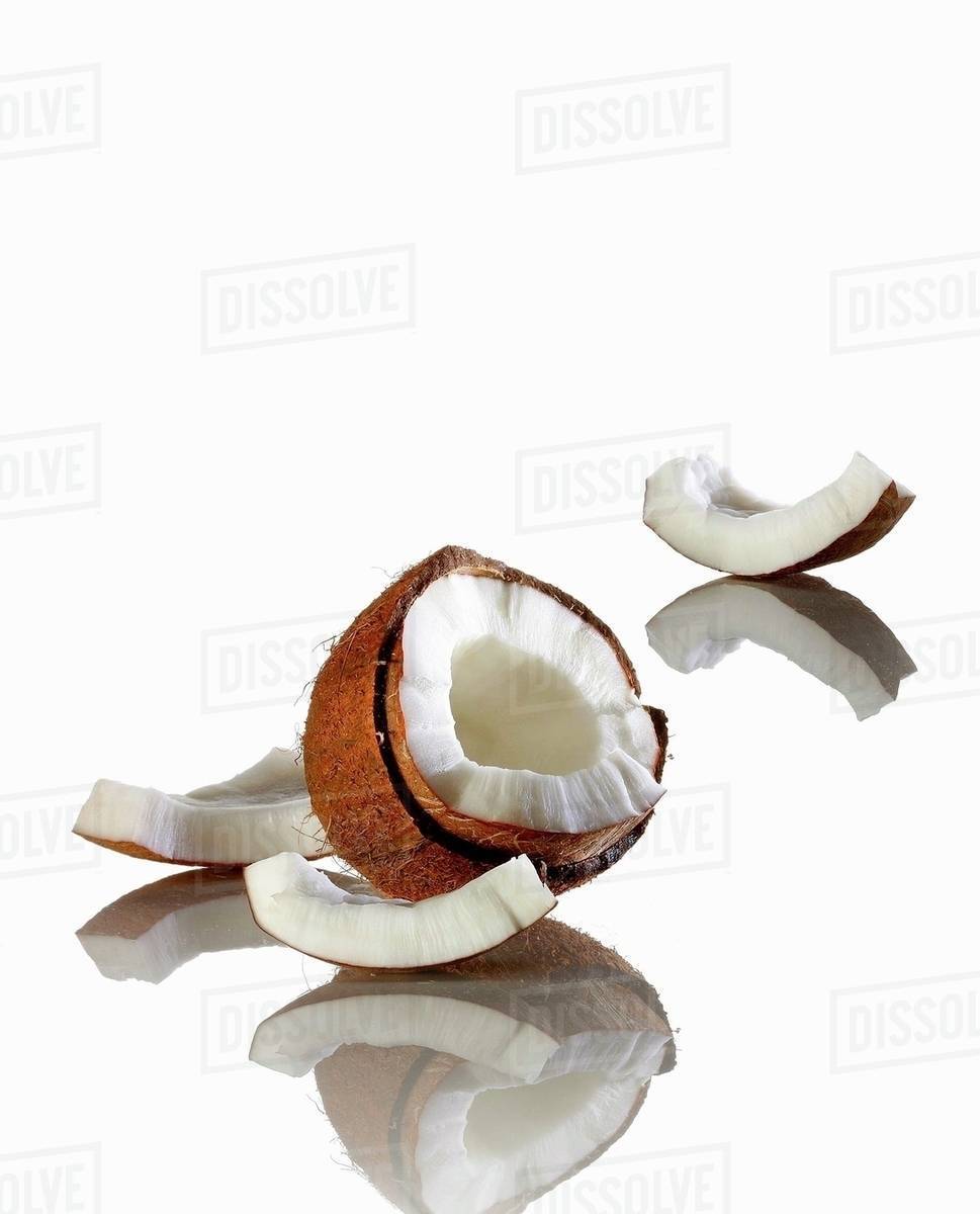 A open coconut on a white surface - Stock Photo - Dissolve