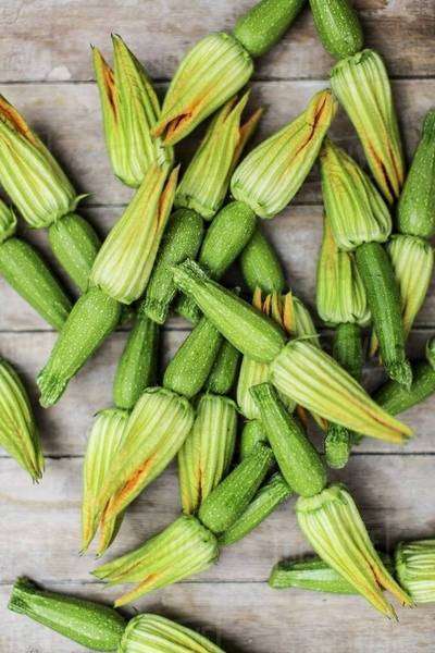 Baby courgettes with flowers - Royalty-free Stock Photo | Dissolve
