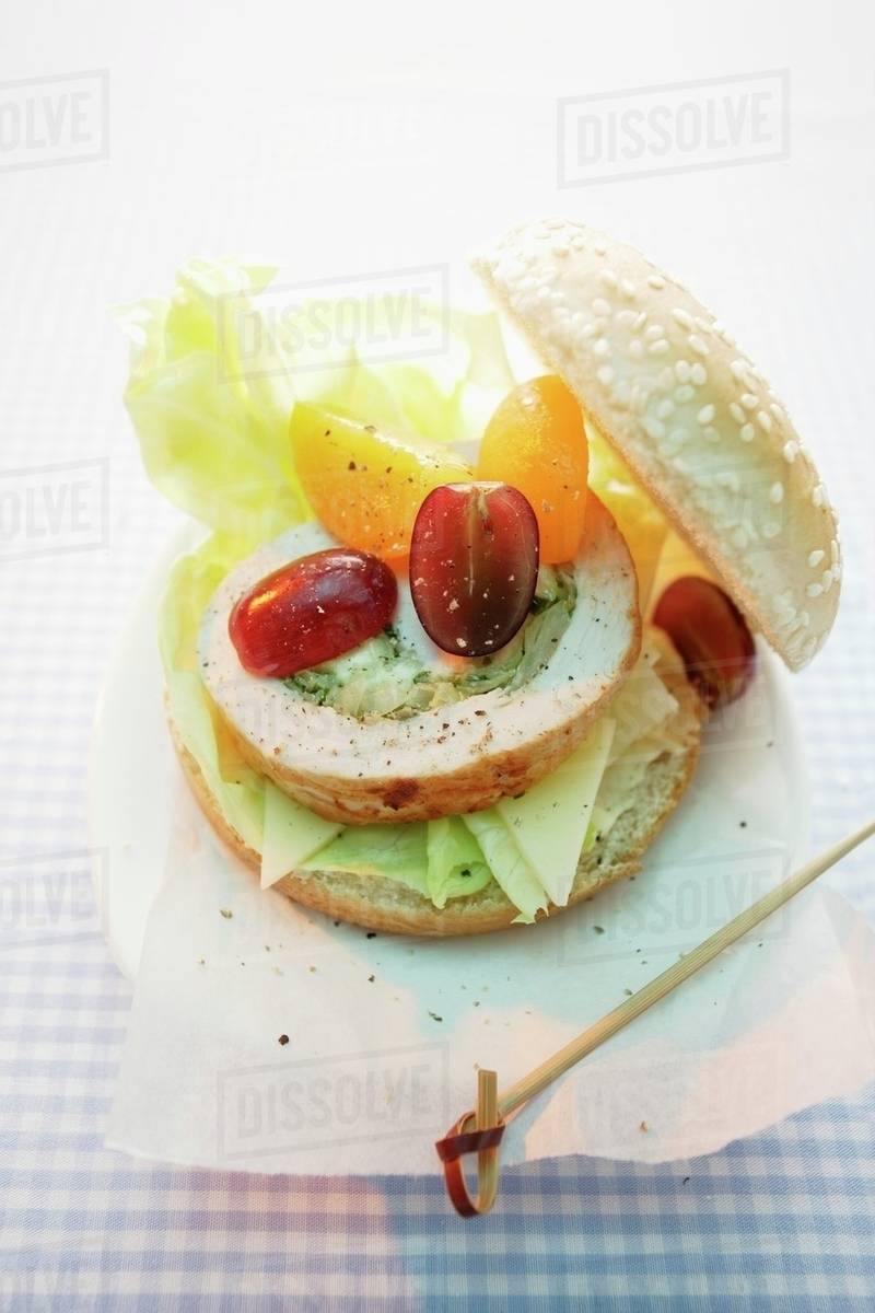 Turkey burger made with a slice of turkey roulade, grapes and yellow ...