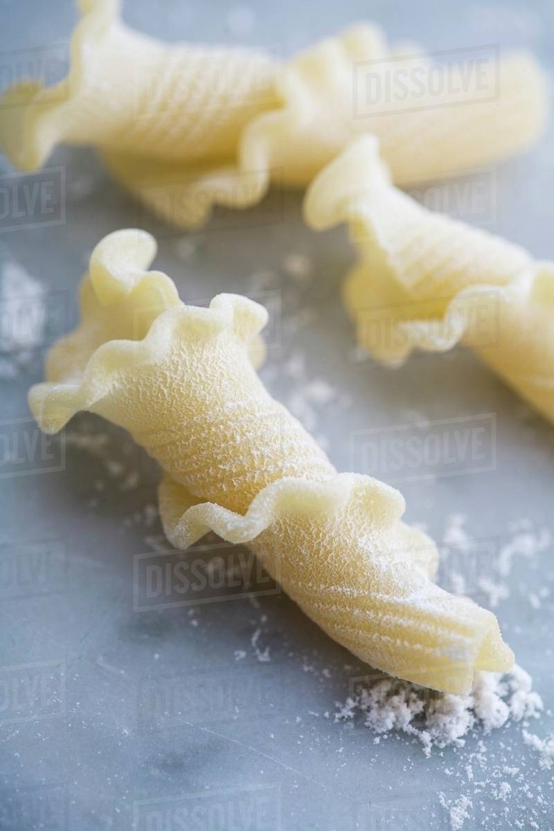 Fresh Gigli Toscani pasta on a floured marble surface - Royalty-free ...