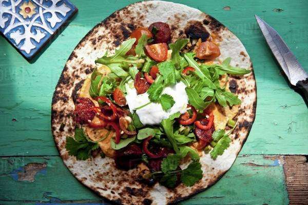 A toasted tortilla with a mixed topping - Stock Photo - Dissolve