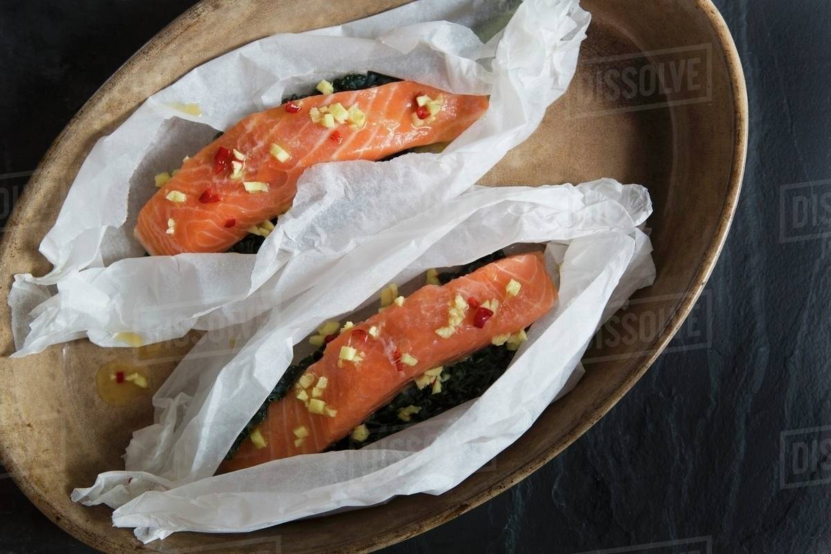 Raw salmon fillets in paper with ginger and chilli - Royalty-free Stock ...