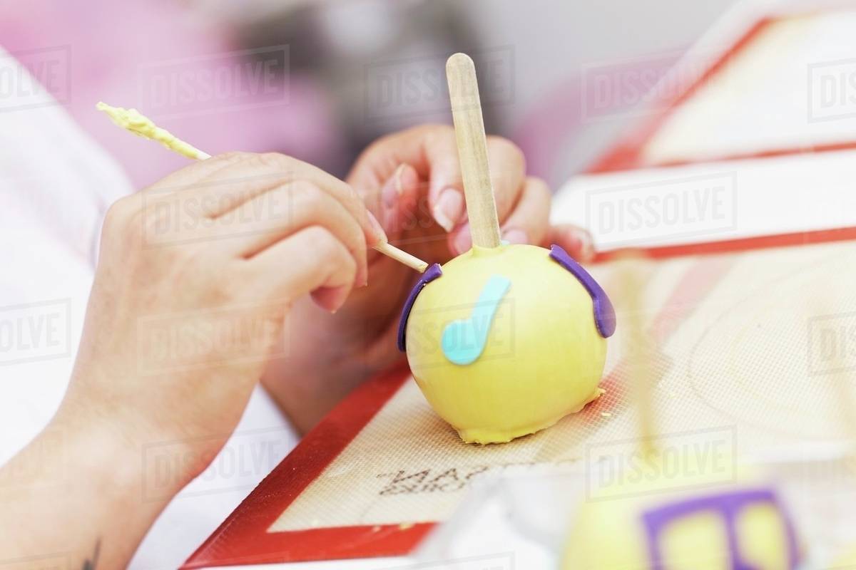A giant cake pop being decorated with music notes - Royalty-free Stock ...