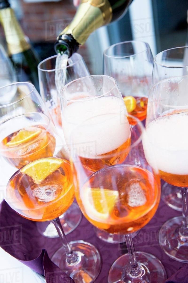 Aperol being topped up with champagne - Stock Photo - Dissolve