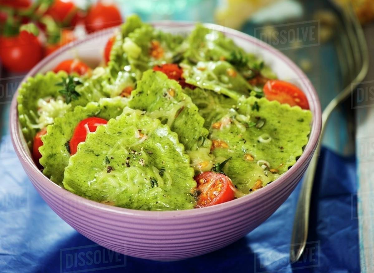 Green ravioli with tomatoes - Stock Photo - Dissolve