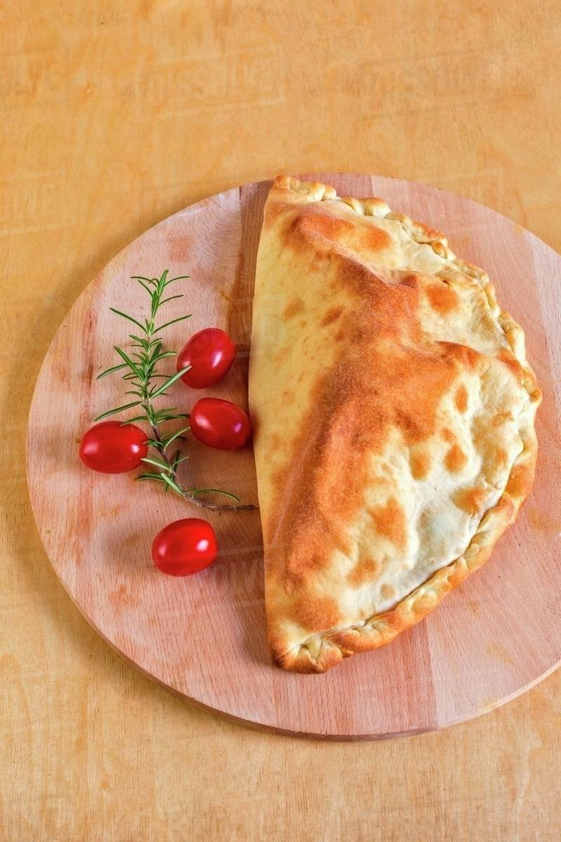 Calzone caprese (a pizza pocket filled with tomatoes and mozzarella ...