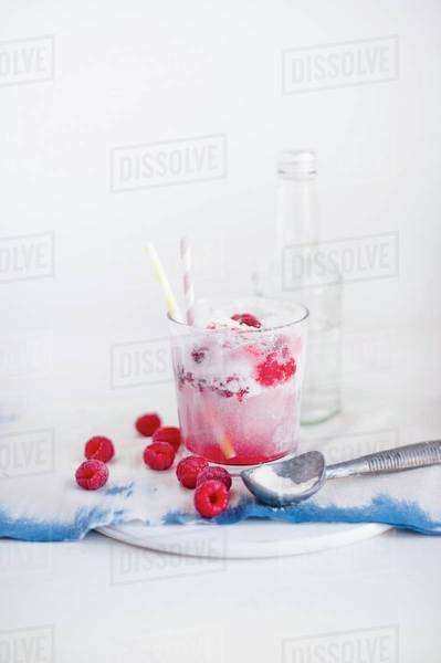 A raspberry and cream float with an ice cream scoop and fresh ...