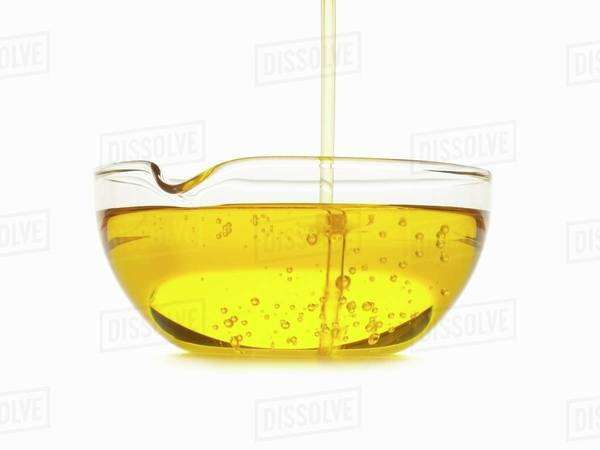 Oil Pouring into a Bowl - Stock Photo - Dissolve