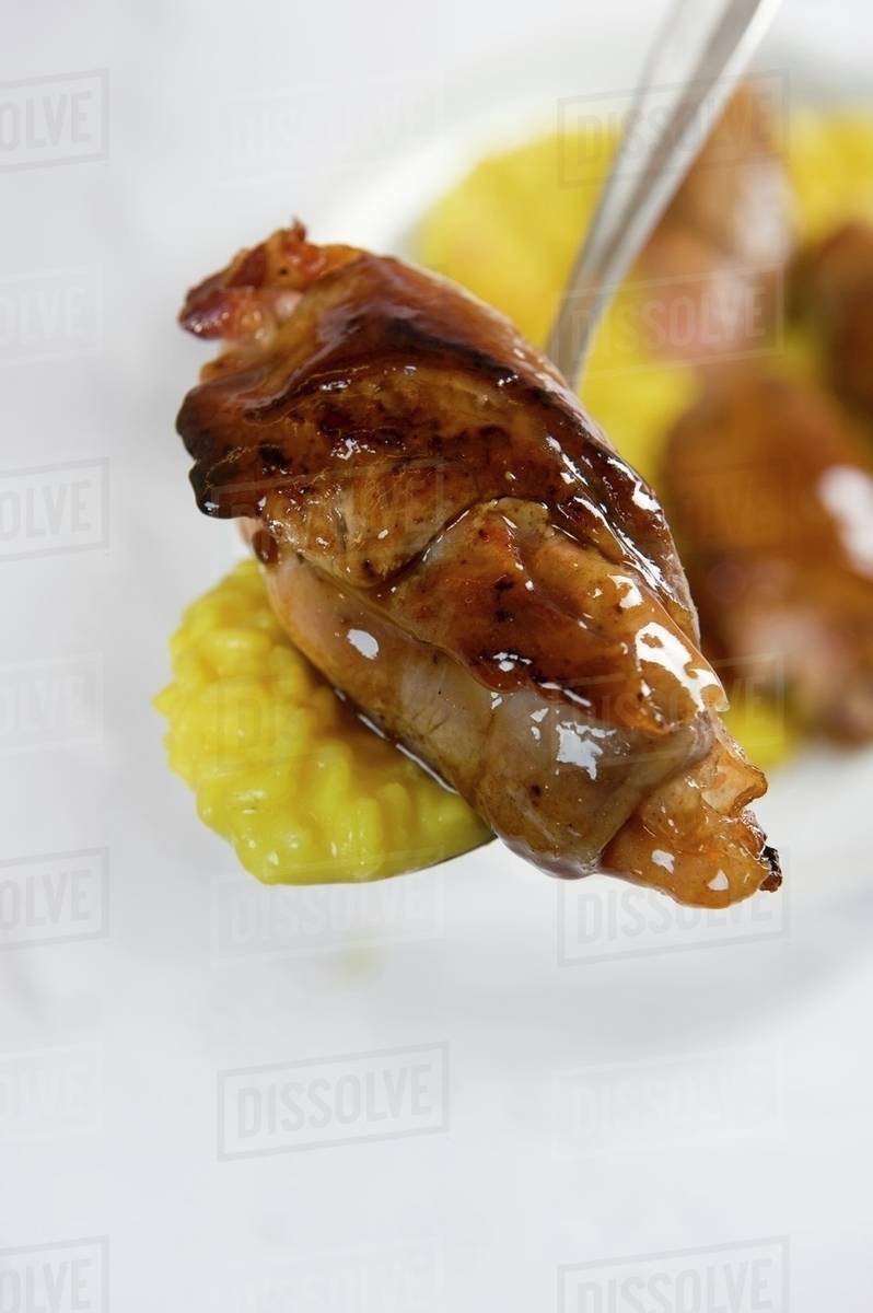 Veal roulade with pancetta on risotto - Stock Photo - Dissolve