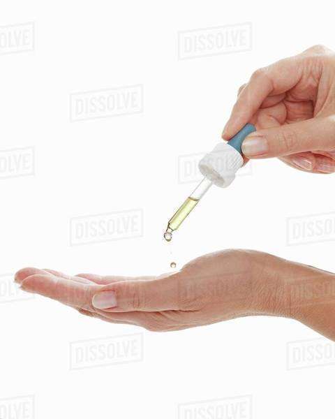 Liquid being dripped onto the palm of the hand with a pipette - Royalty ...