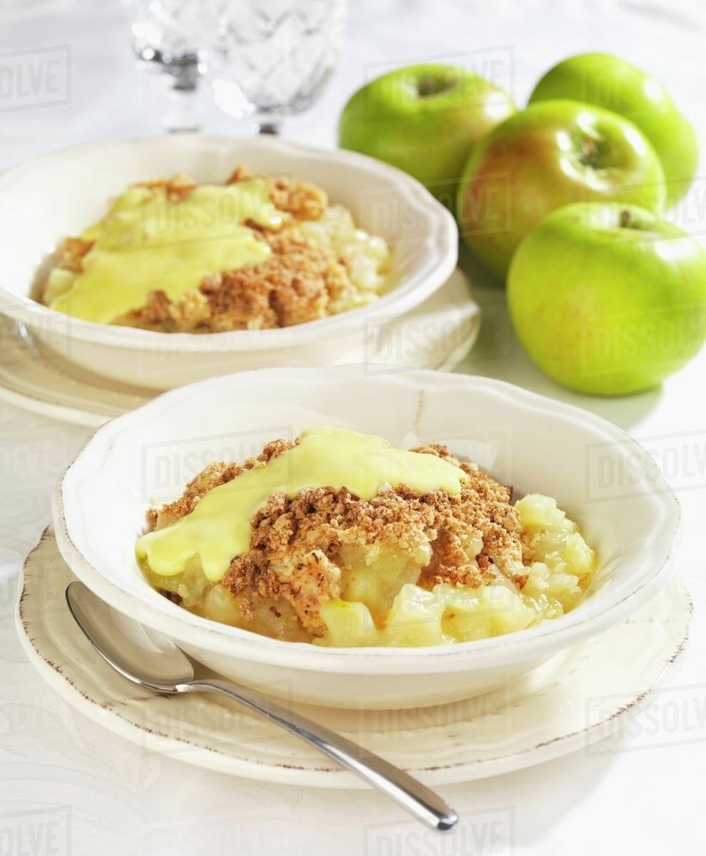 Apple crumble with custard - Royalty-free Stock Photo | Dissolve