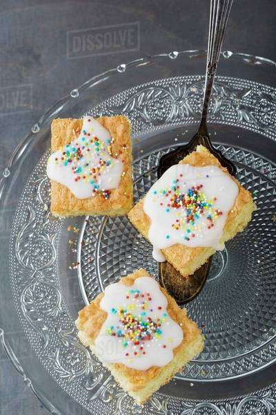 Slices of cake with icing and colourful sprinkles - Royalty-free Stock ...