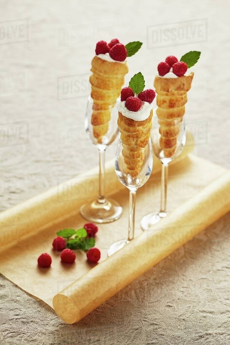 Puff pastry cones with cream and raspberries - Royalty-free Stock Photo ...