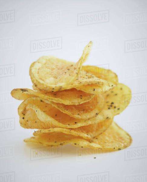 A stack of crisps on a white surface - Royalty-free Stock Photo | Dissolve