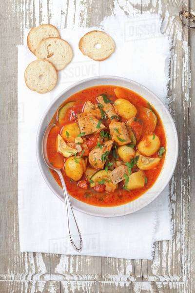 Braised tuna with potatoes and courgette in tomato sauce - Stock Photo ...