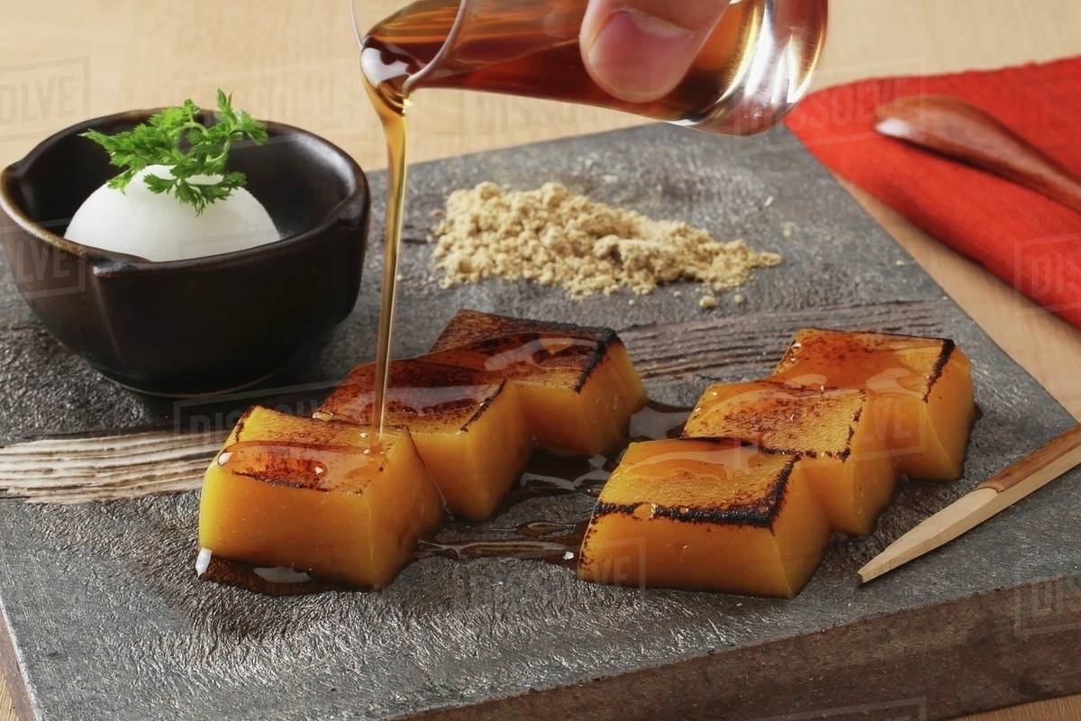 Tapioca rice cakes being drizzled with a honey sauce - Stock Photo ...