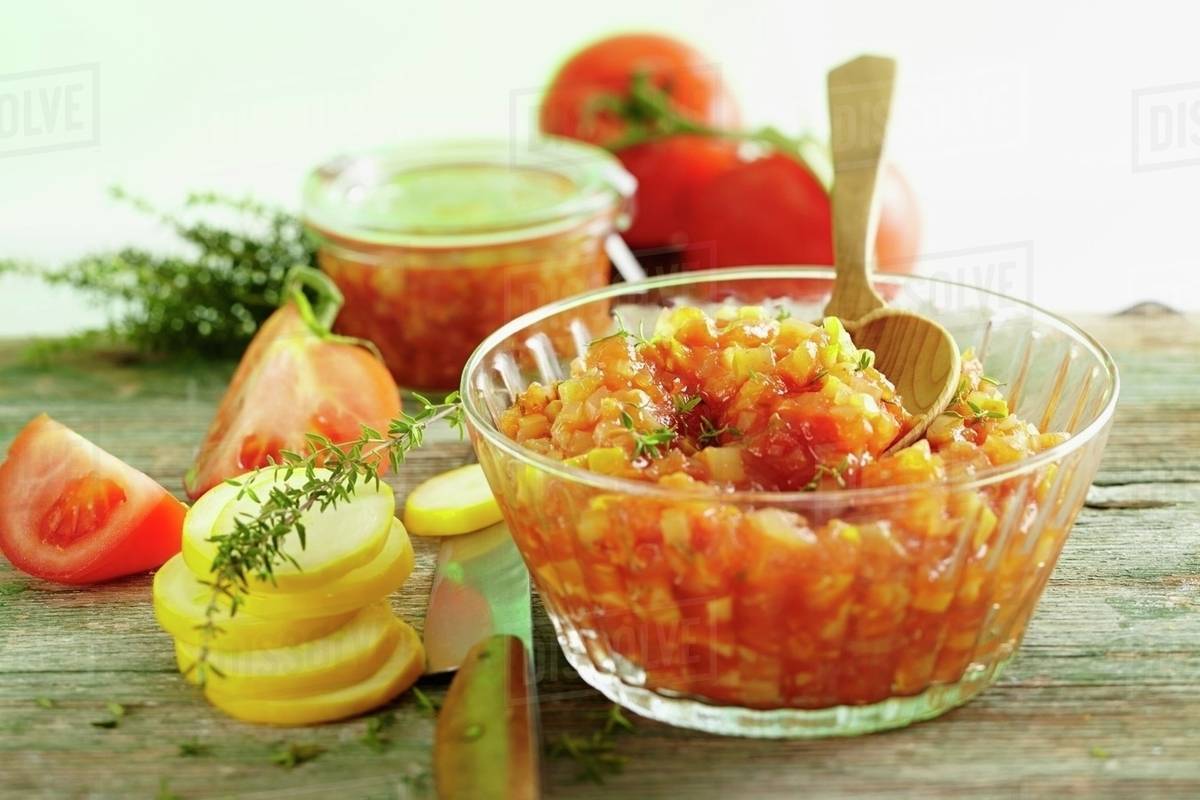 Courgette and tomato chutney with ingredients - Stock Photo - Dissolve