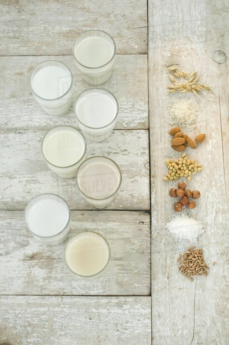 Various types of lactose-free milk in glasses (seen from above ...