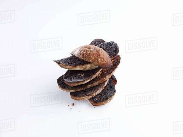 A stack of charred bread slices in front of white background - Stock ...