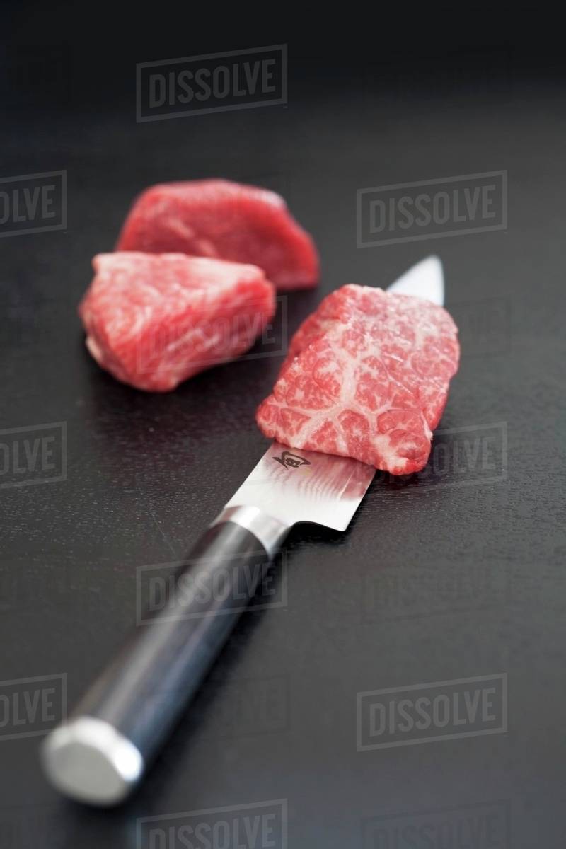 Wagyu beef on a knife blade - Stock Photo - Dissolve