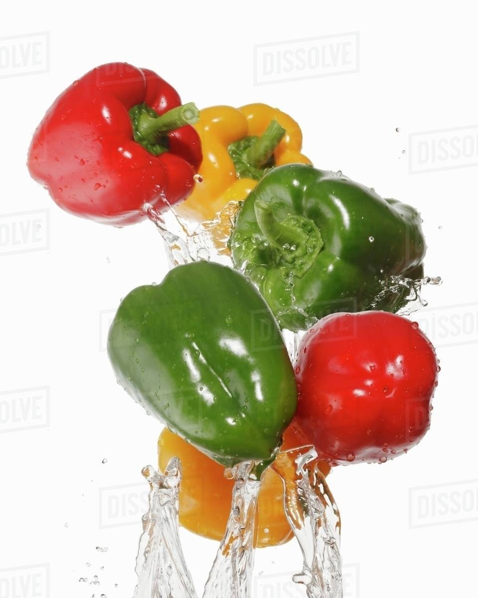 Colourful peppers being washed - Royalty-free Stock Photo | Dissolve