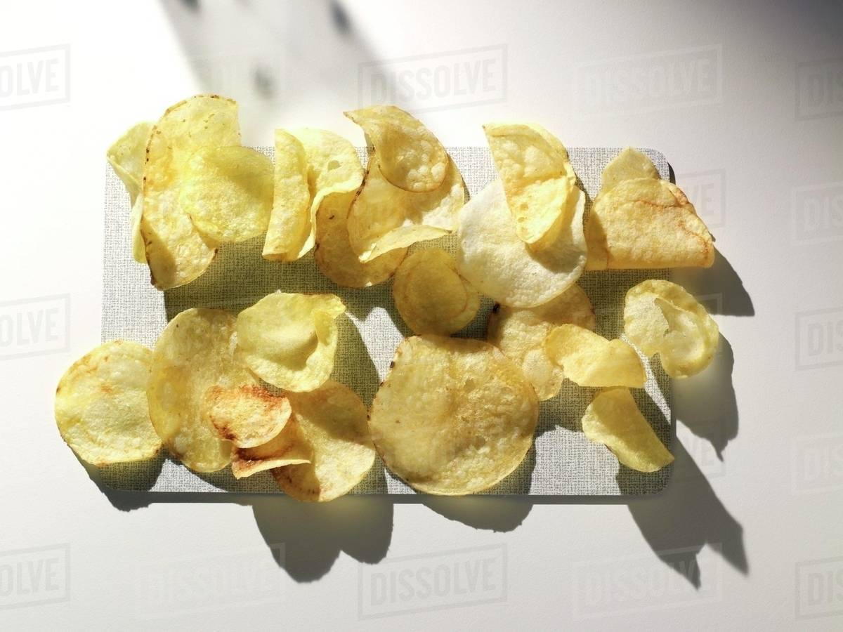 Potato crisps on a cutting board (view from above) - Royalty-free Stock ...