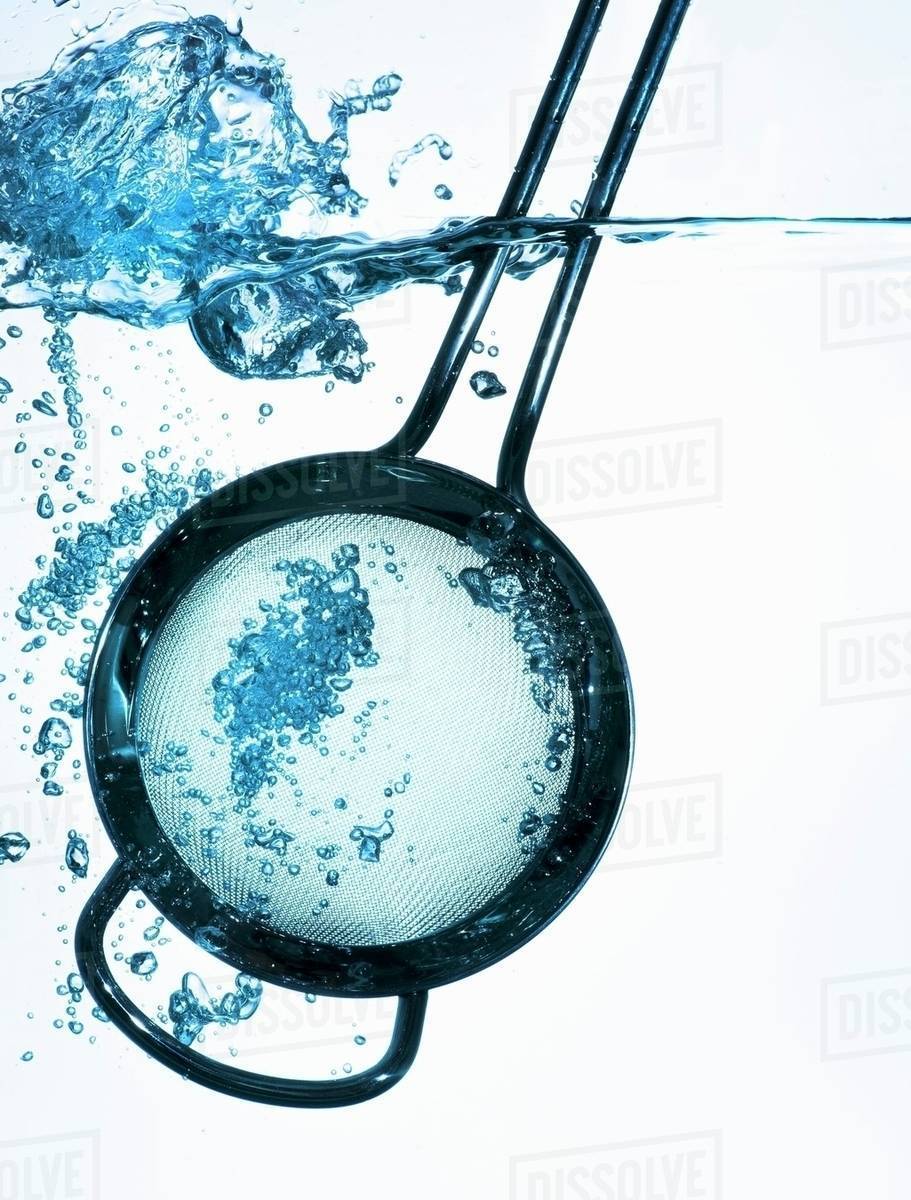 A kitchen sieve in water - Royalty-free Stock Photo | Dissolve