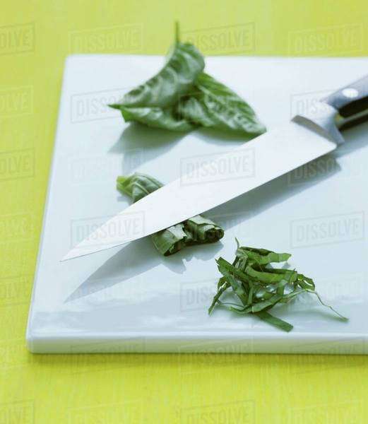 Basil being finely sliced - Royalty-free Stock Photo | Dissolve