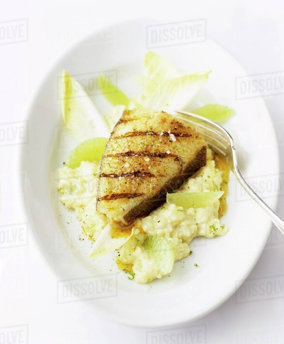 Grilled fish fillet on risotto with chicory - Royalty-free Stock Photo ...